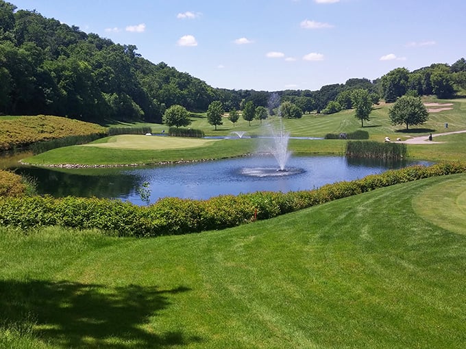 The golf course adds manicured green luxury to wild park surroundings, because sometimes nature needs a proper haircut and fountain feature.
