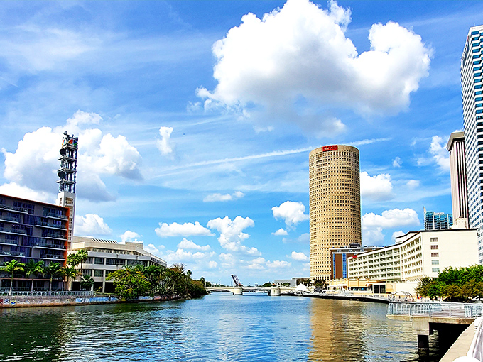Tampa's iconic cylindrical tower stands like a sentinel watching over the river. On clear days, it reflects the sky like it's trying on a blue suit.