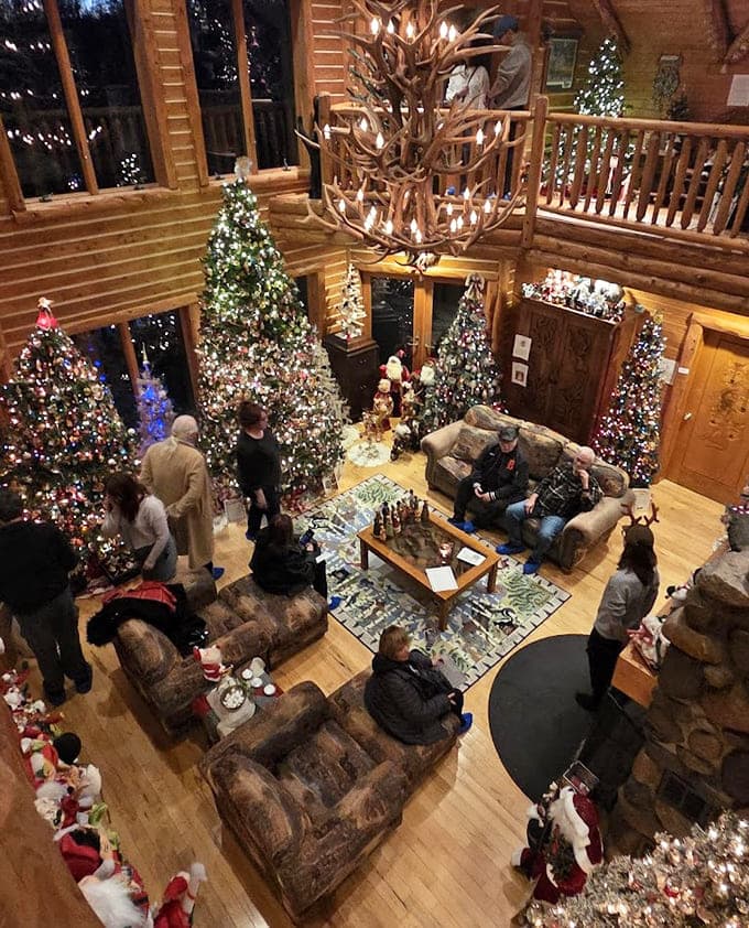 From this bird's-eye view, visitors bask in the glow of multiple Christmas trees while an antler chandelier watches from above.