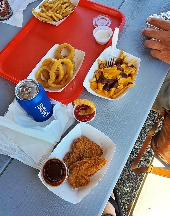 Fuel up for your adventures with a delicious spread of crispy chicken tenders, golden onion rings, and cheesy fries.