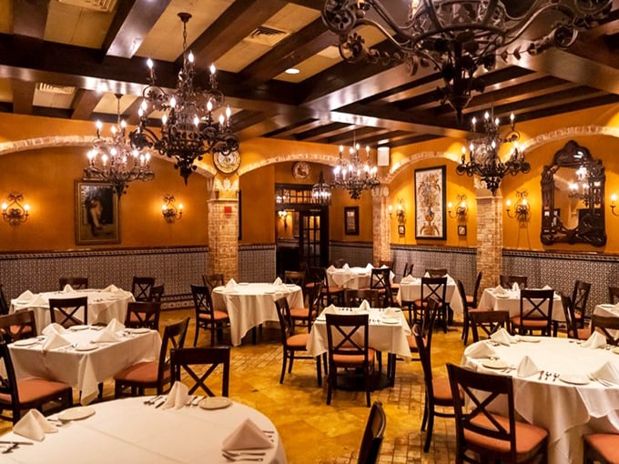 Chandeliers cast a golden glow over white tablecloths, creating an atmosphere where every meal feels like a special occasion.