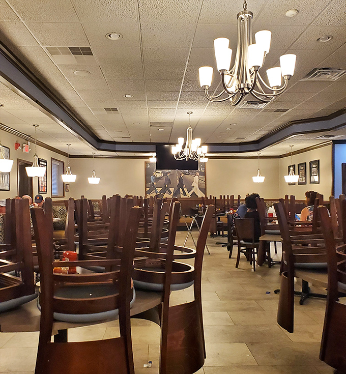 Inside: Empty chairs await the lunch rush in this Beatles shrine where chandeliers cast a golden glow over tables ready for hungry fans.