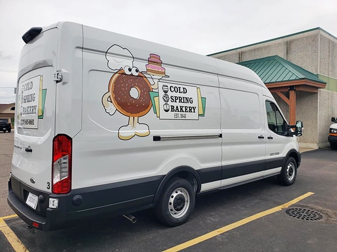 The bakery's delivery van, sporting their cheerful donut mascot, bringing joy to neighborhoods throughout the area.