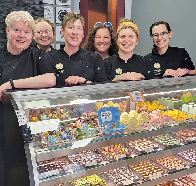 The team behind the magic, smiling people who clearly love creating beauty you can eat, their pride evident in every carefully placed piece.