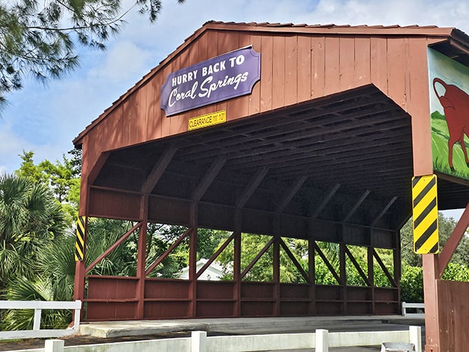 The historic covered bridge creates a striking silhouette against the blue Florida sky, its wooden frame a testament to enduring craftsmanship.