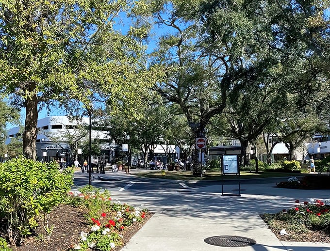 Lush landscaping creates natural pathways through the village, where shopping becomes a garden stroll punctuated by credit card swipes and shopping bags.