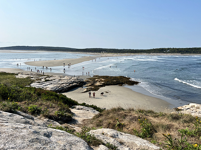 Beachgoers become tiny figures against Popham's vast landscape, finding their perfect spot on this expansive sandy playground.