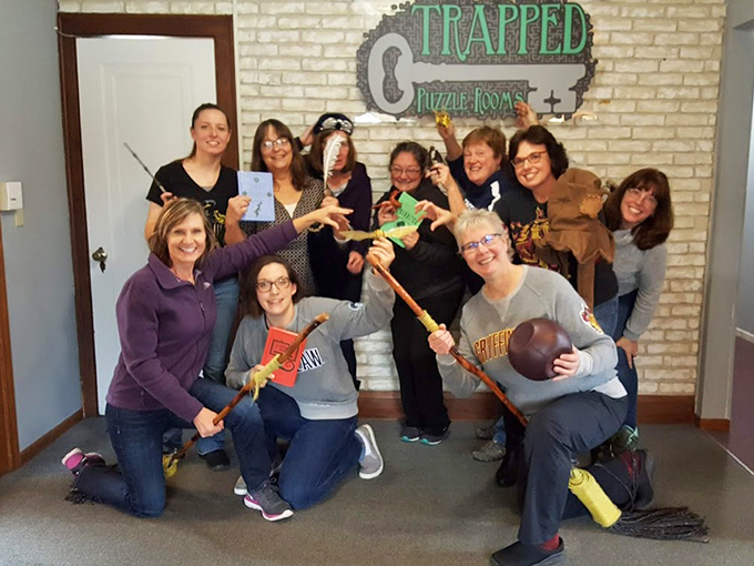 These victorious witches and wizards brandish their magical implements after successfully completing their quest &ndash; broomsticks and all!