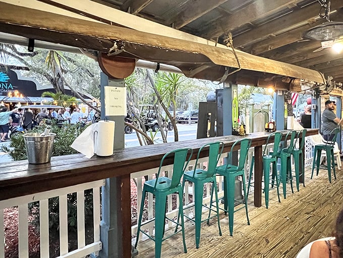 Another angle reveals more seating where weathered wood and turquoise accents create that "I've discovered something special" atmosphere.