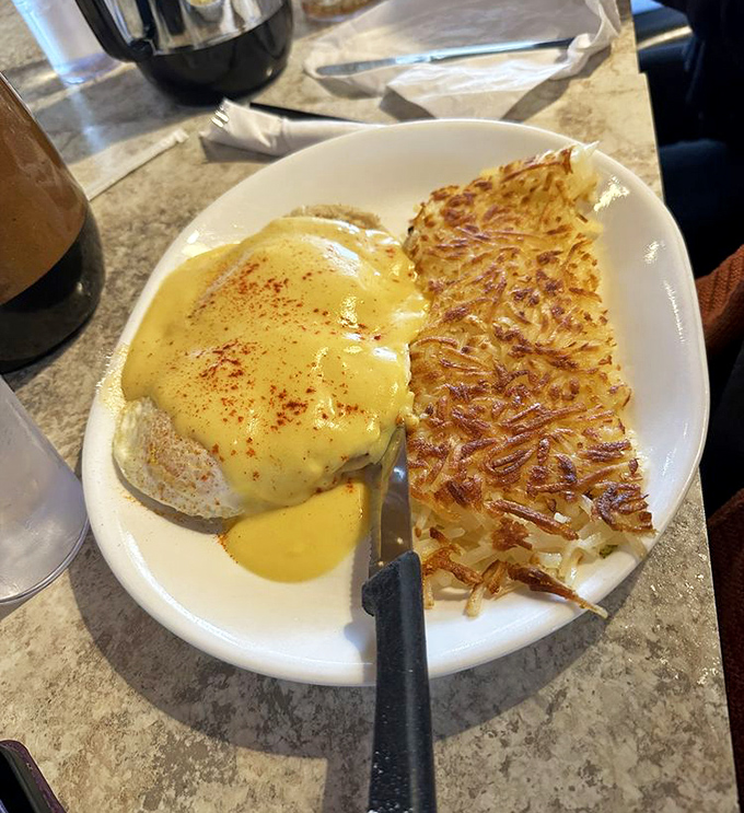 Eggs Benedict with perfectly poached eggs and hollandaise sauce that would make a French chef nod in approval.