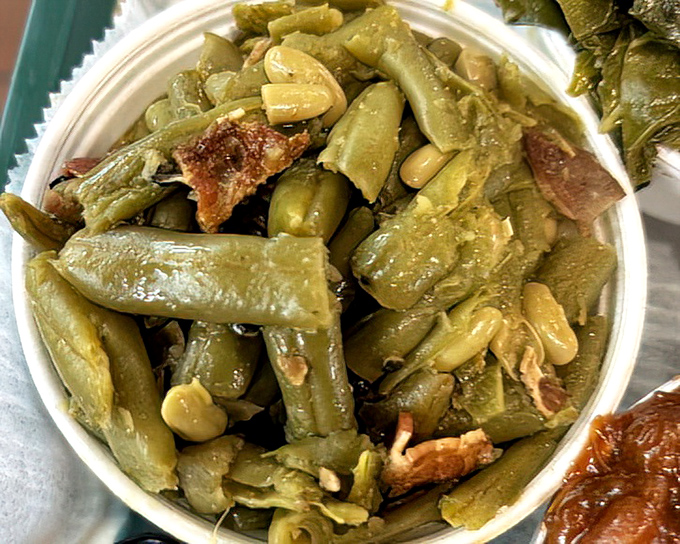 These aren't your cafeteria green beans &ndash; slow-cooked with bits of pork and seasoning that transforms the humble vegetable into a star.