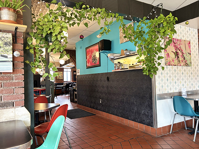 Turquoise walls, hanging plants, and geometric patterns create a space that feels both trendy and timeless &ndash; the perfect backdrop for plant-based culinary adventures.