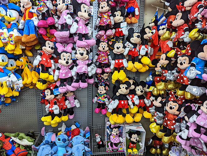 Plush Disney characters stand at attention, ready to accompany visitors home as cuddly souvenirs of Florida adventures.