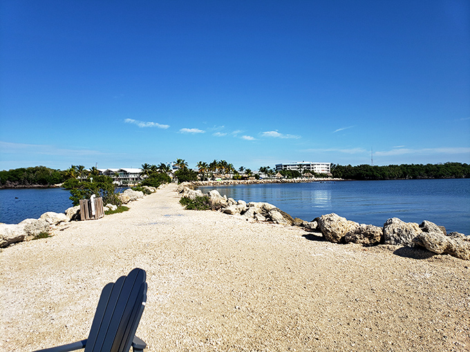 The shell-strewn path hugs the shoreline, offering strollers panoramic views and the constant soundtrack of gentle waves.