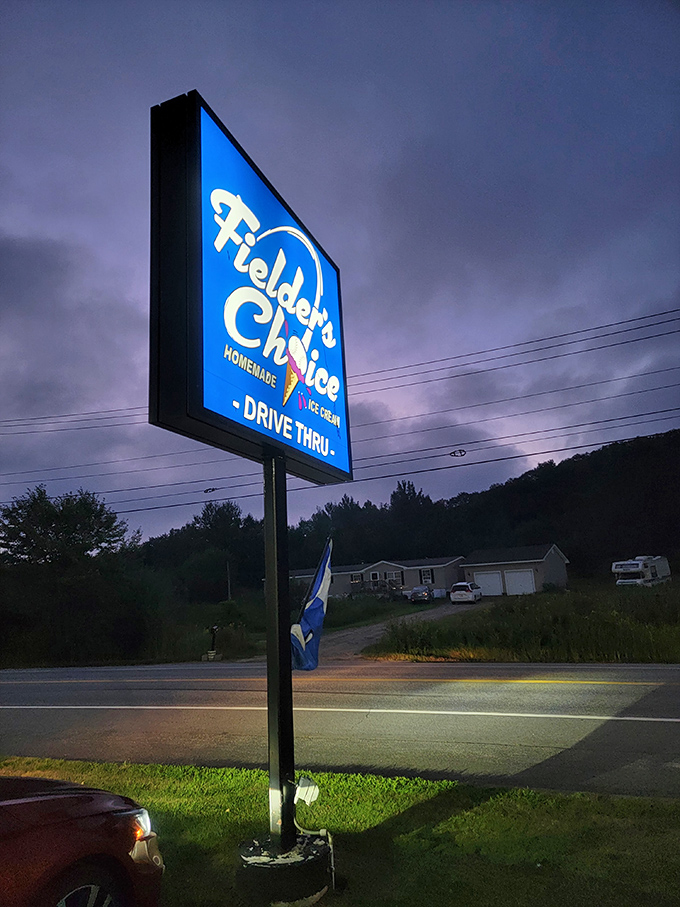 The illuminated sign calls to ice cream lovers like moths to a deliciously cold flame.