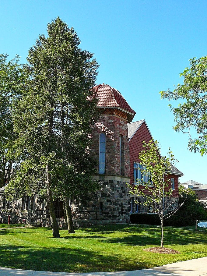 Starkweather Hall's distinctive stone tower and red roof showcase the Victorian architecture that gives Ypsilanti its timeless character.