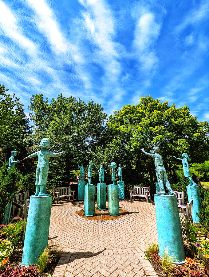 Bronze children reach skyward in joyful abandon, capturing that fleeting moment of pure childhood exuberance that adults secretly wish they could reclaim.
