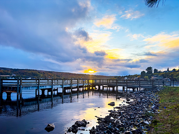 Golden hour transforms the waterfront into a postcard-perfect scene, with the wooden pier extending into waters that Finnish immigrants once crossed to reach America.