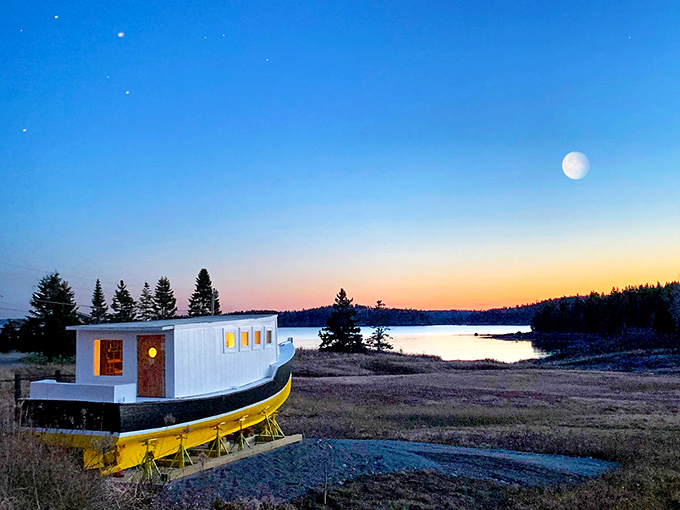 When day meets night, the beached boat becomes silhouetted against Maine's spectacular twilight sky show.