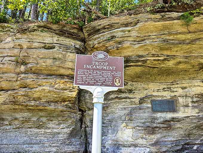 History stands etched in bronze, telling tales of troops who once sought shelter beneath these same ancient stone formations.