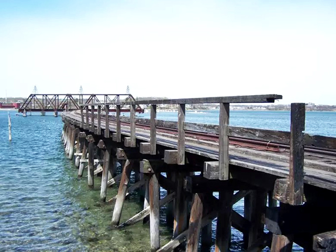 This wooden railway bridge section has weathered storms, fires, and neglect, yet still maintains a certain dignity in its slow surrender to time.