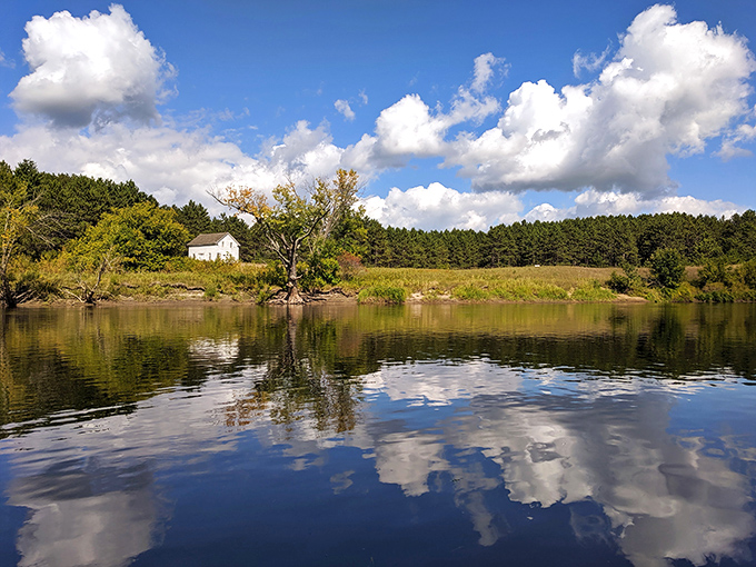 Mirror-like waters reflect Minnesota's perfect sky, doubling the beauty that frontier settlers once called home.