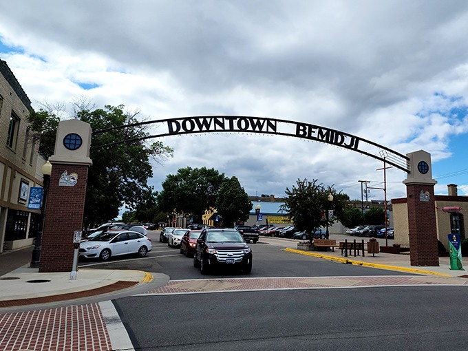 Downtown Bemidji's welcoming arch invites visitors to explore beyond the statues, where local flavor awaits just steps away.