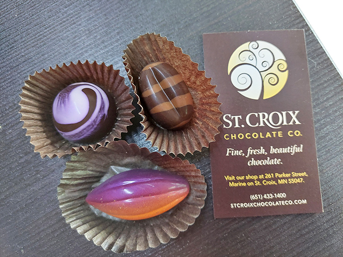 The shop's motto displayed alongside sample chocolates, "Fine, fresh, beautiful" isn't marketing hype but accurate description of everything you'll find here inside.