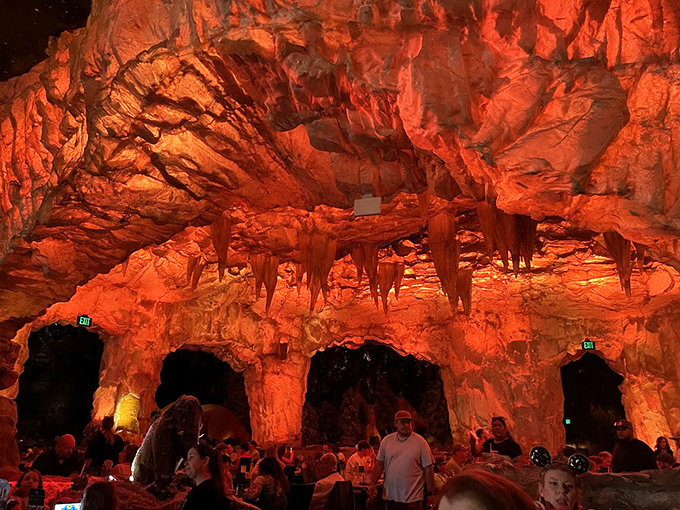 The fiery cavern dining area glows with primeval energy, creating an atmosphere where every bite feels like a discovery.