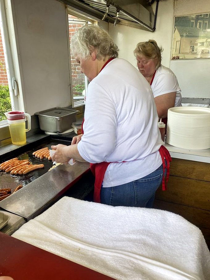 Behind the scenes magic &ndash; where hot dog dreams come true on a well-seasoned grill that's seen decades of delicious service.