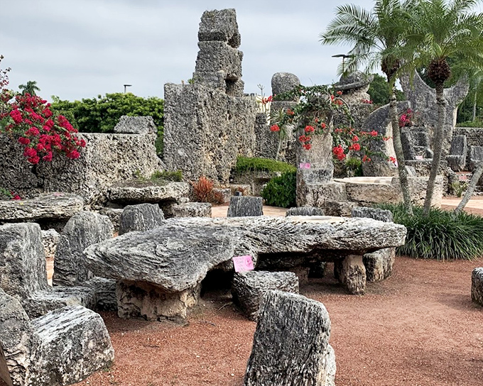 Massive coral tables and benches create gathering spaces throughout the grounds, perfect for contemplating life's mysteries.