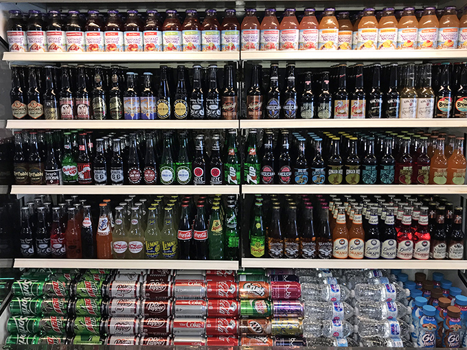 Not your average beverage selection &ndash; bottles lined up like colorful soldiers ready for taste bud duty.