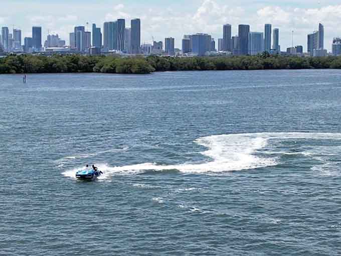 Cruising past the cityscape with a wake trailing behind, this floating car makes every other boat in the bay look like they're not even trying.