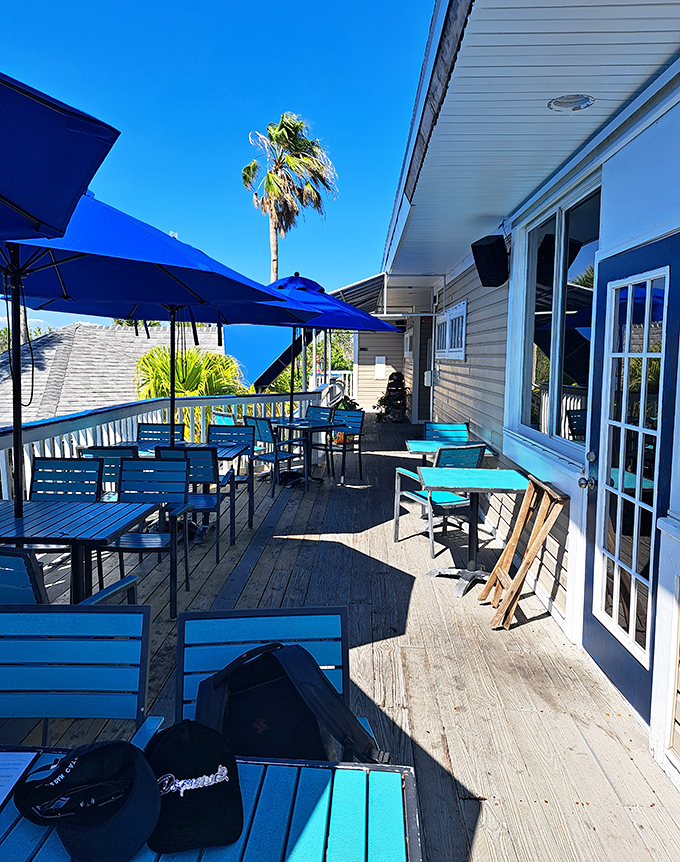 Deck seating: Turquoise tables under a perfect sky&mdash;where lunch comes with a side of vitamin D and gentle Gulf breezes.