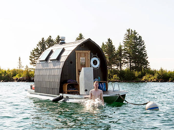 A brave soul emerges from Lake Superior's chilly embrace after a hot sauna session, experiencing Minnesota's version of a natural roller coaster.
