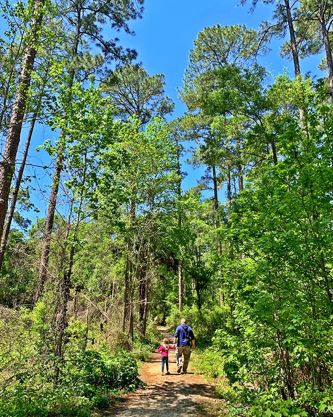 Father-daughter moments on nature's highway. This serene forest trail connects the various caves and sinkholes throughout the four-mile loop.