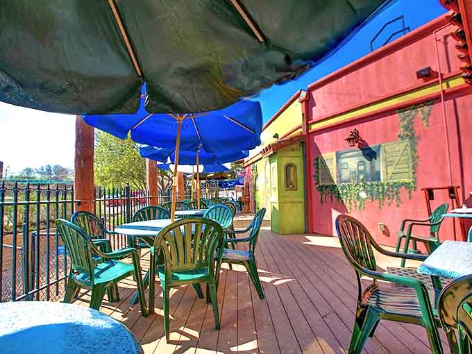 The outdoor patio, with its turquoise chairs and blue umbrellas, creates a tranquil oasis for enjoying margaritas and sunshine in equal measure.