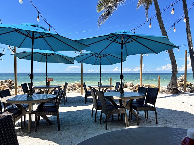 The outdoor patio with those turquoise umbrellas is where memories are made &ndash; sand between your toes optional but highly recommended.