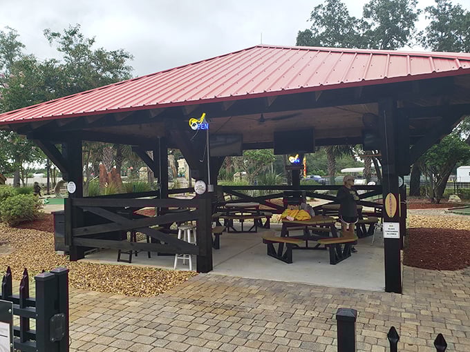 The community pavilion serves as a gathering spot for everything from impromptu picnics to scheduled events under its protective red roof.