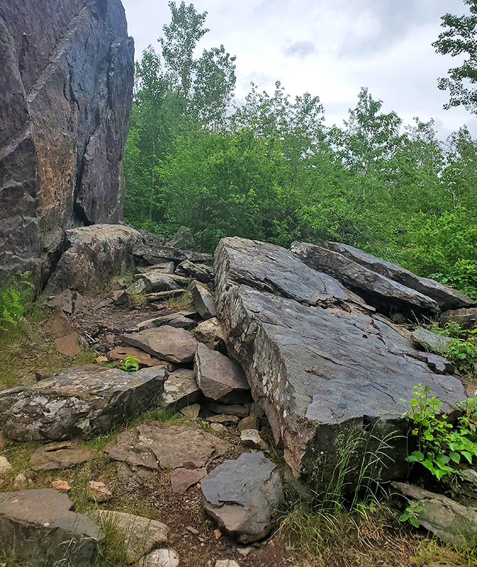 Nature's staircase leads adventurous hikers toward their towering destination, each step bringing them closer to geological fame.