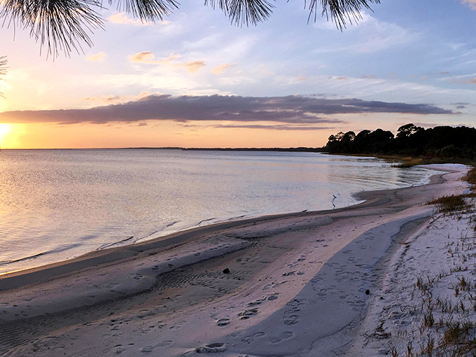 Golden hour magic transforms the coastline into a painter's dream, with soft pastels reflecting off the gentle Gulf waters.