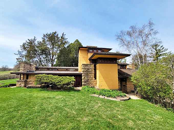 Frank Lloyd Wright's Taliesin emerges from the hillside like a natural extension of the landscape, architectural genius in harmony with nature.