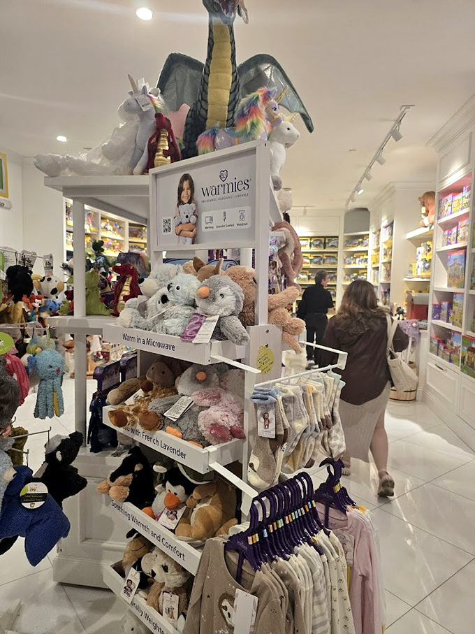 The toy shop bursts with plush creatures and childhood dreams, where unicorns and dragons perch above practical parental wallets.