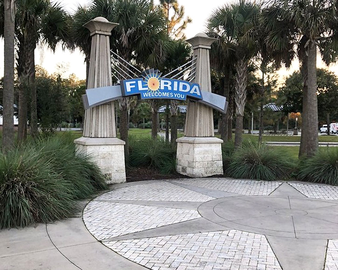 Golden hour bathes the welcome arch in warm light, nature's way of saying "Good choice on your vacation destination!"