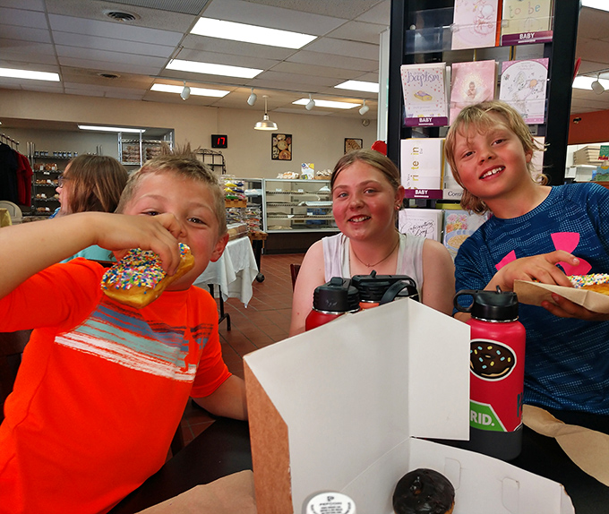 Young customers experiencing the pure joy that only comes from that first bite of a perfect bakery treat.