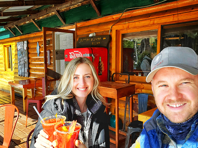 Happy diners toasting with colorful drinks on the porch&mdash;where every meal comes with a side of fresh air and forest views.