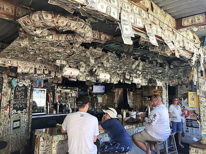 Patrons belly up to the dollar-bill-covered bar, where strangers quickly become friends over cold beers and fish stories.