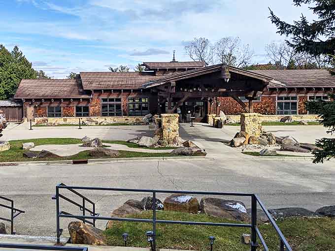 The entrance building welcomes visitors with its Prairie-style architecture, stone pillars standing like sentinels guarding wonderland within.
