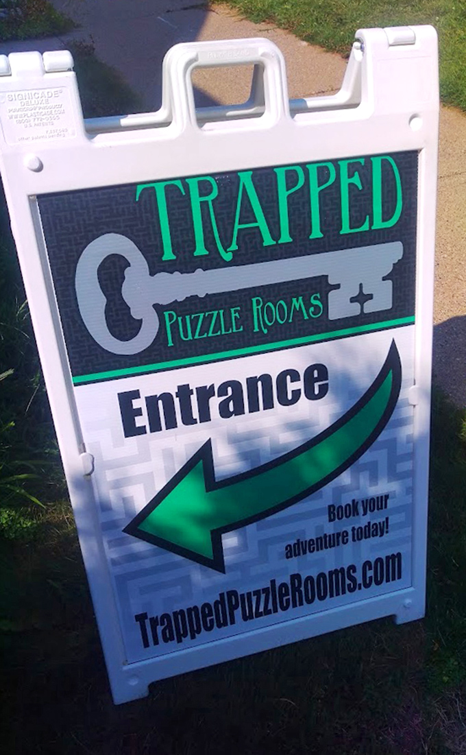 The sidewalk sign points the way to adventure with its distinctive key logo and green arrow &ndash; your first clue to finding magical fun.