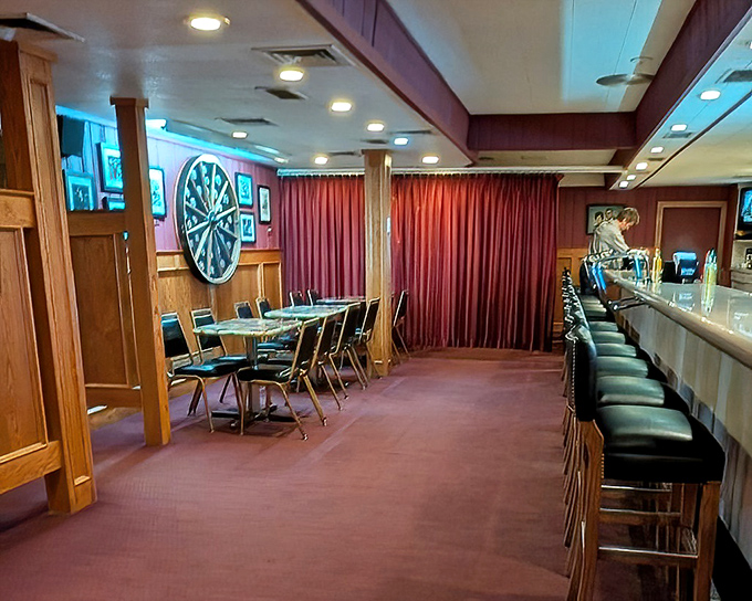 The bar area offers a more casual dining experience, where regulars perch on stools beneath the glow of pendant lights and decades of good conversations.